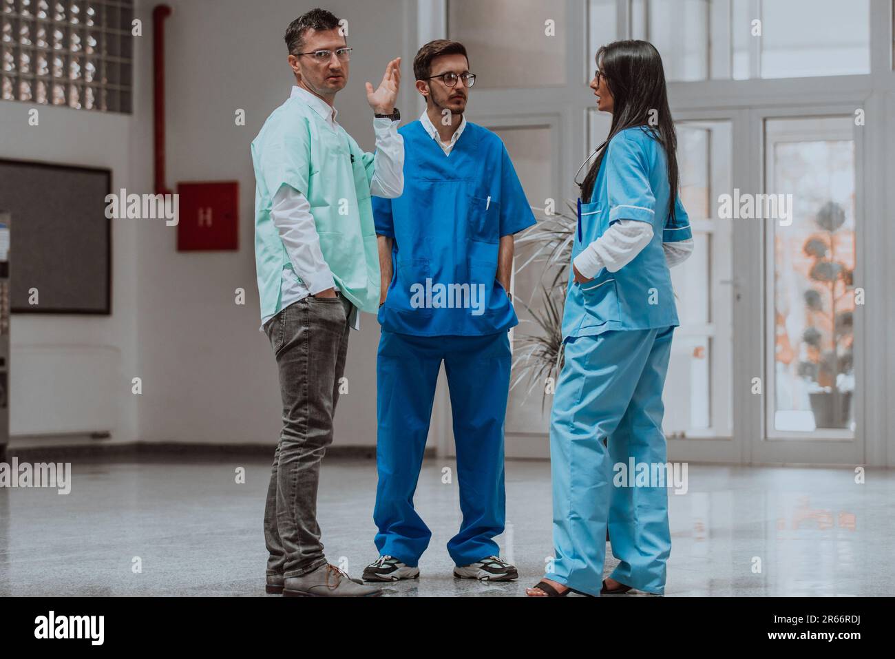 A nurse, medical technician, and doctor engage in a discussion on ...