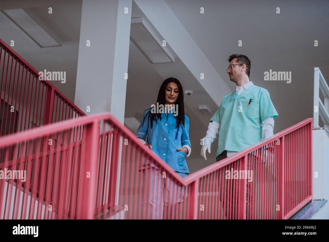 A doctor in a discussion with a nurse about medical problems and ...