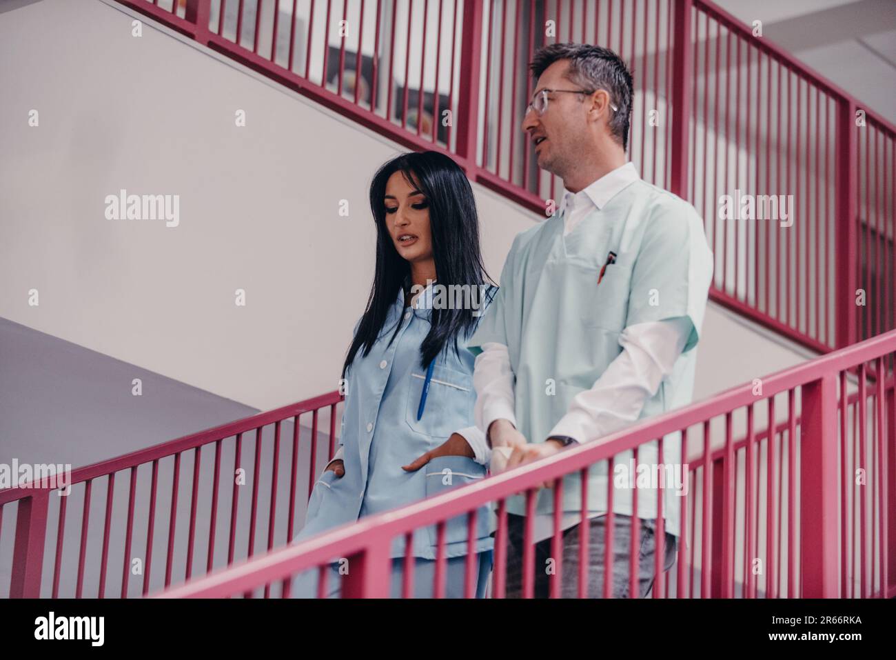 A doctor in a discussion with a nurse about medical problems and ...