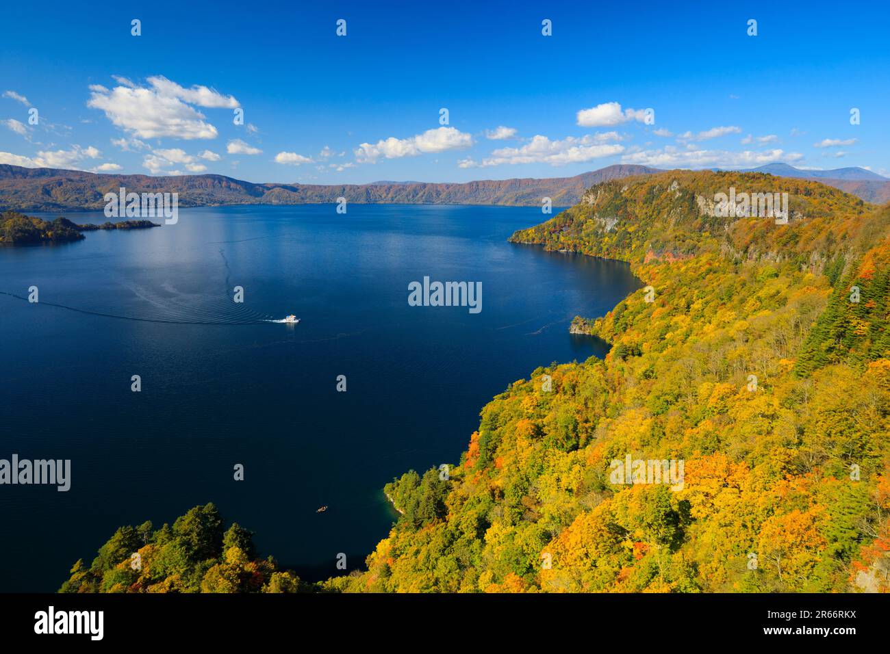 Lake Towada and tour boats with fall colors Stock Photo - Alamy