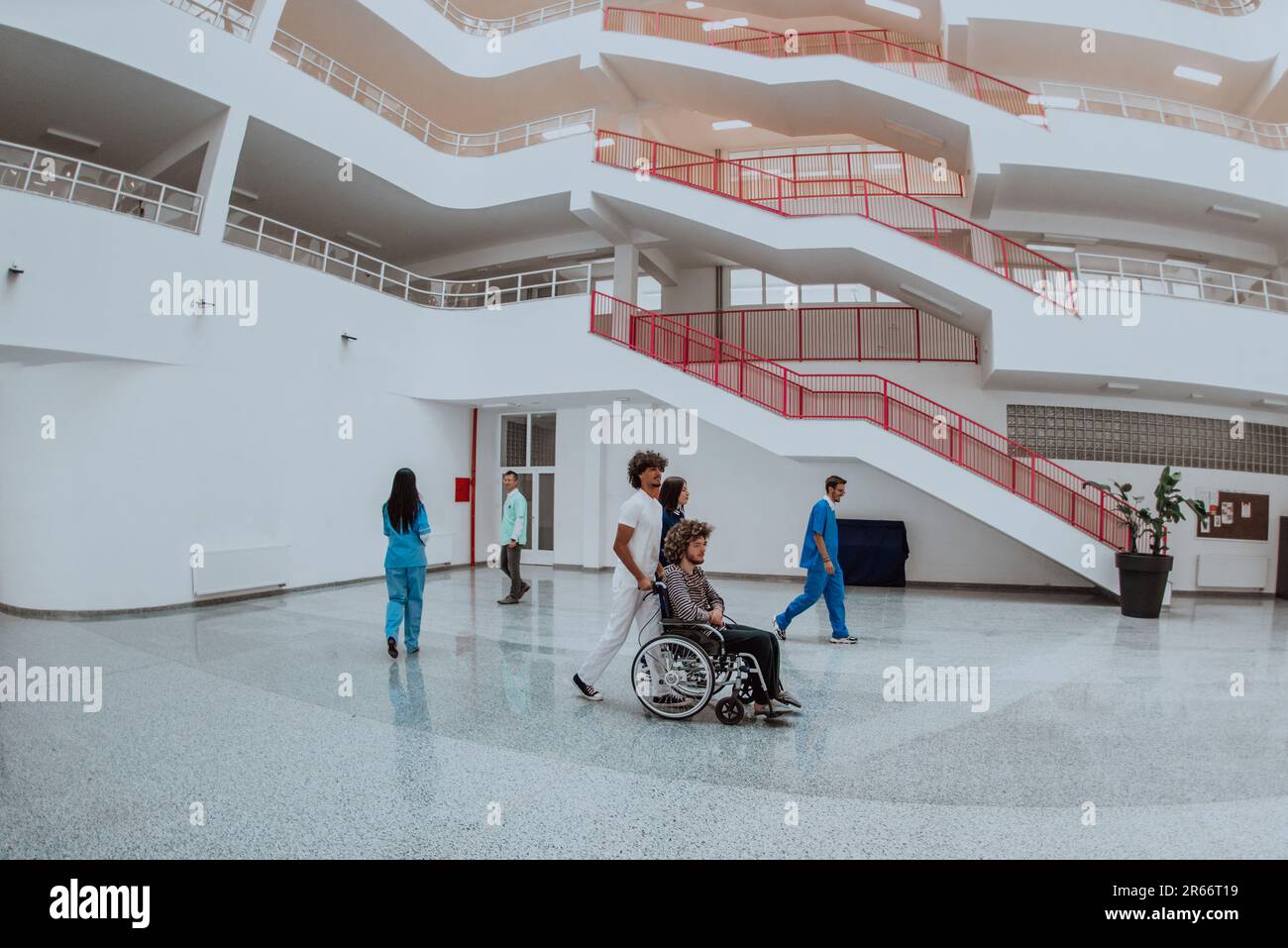 The atmosphere of hospital life. Doctors, with a patient in a ...