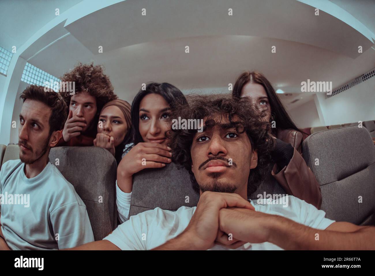 A diverse group of friends with terrified expressions together in a ...