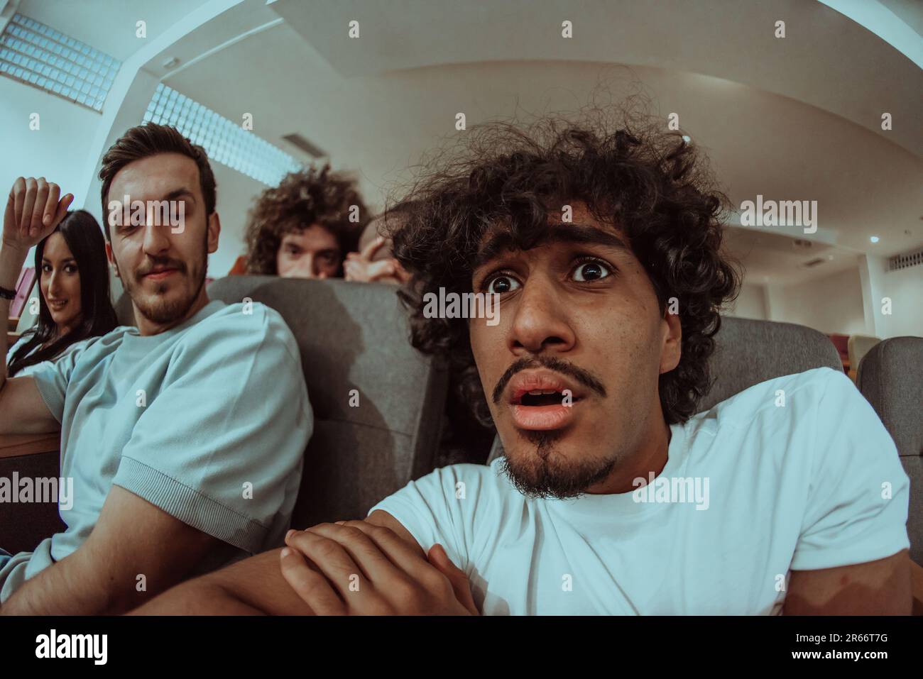 A diverse group of friends with terrified expressions together in a ...