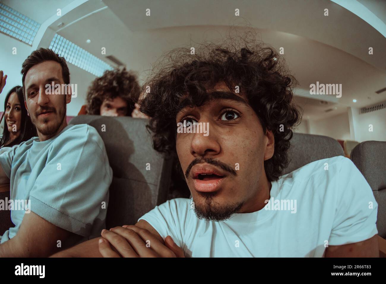 A diverse group of friends with terrified expressions together in a ...