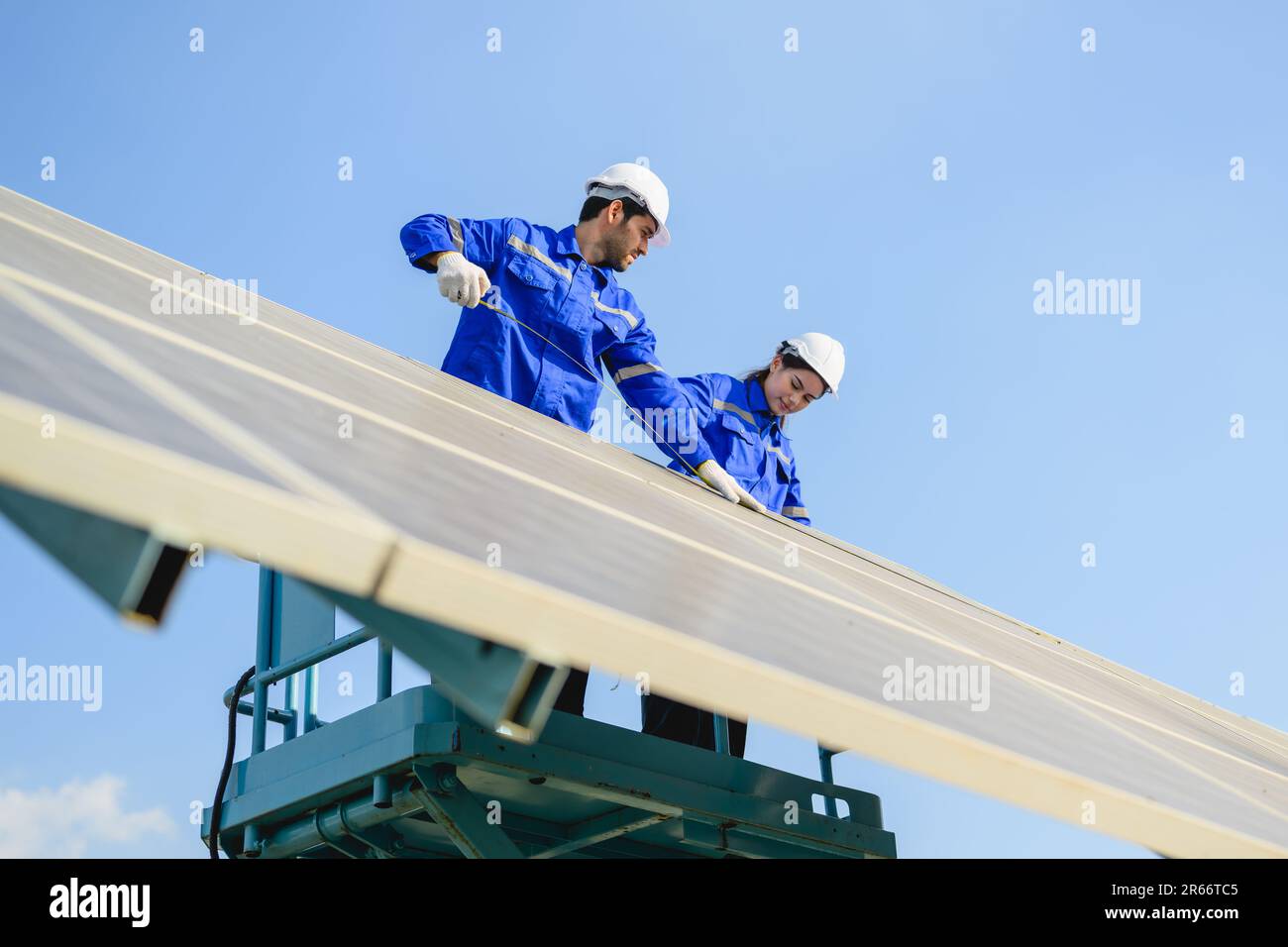 Technicians workers installing solar panels at solar cell farm Stock ...