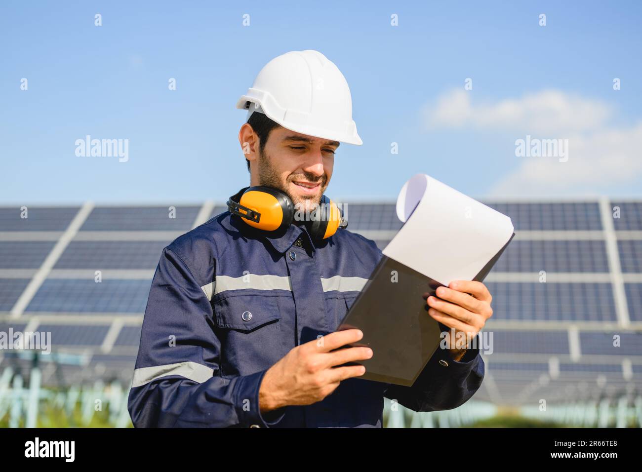 Technician worker installing solar panels at solar cell farm Stock ...