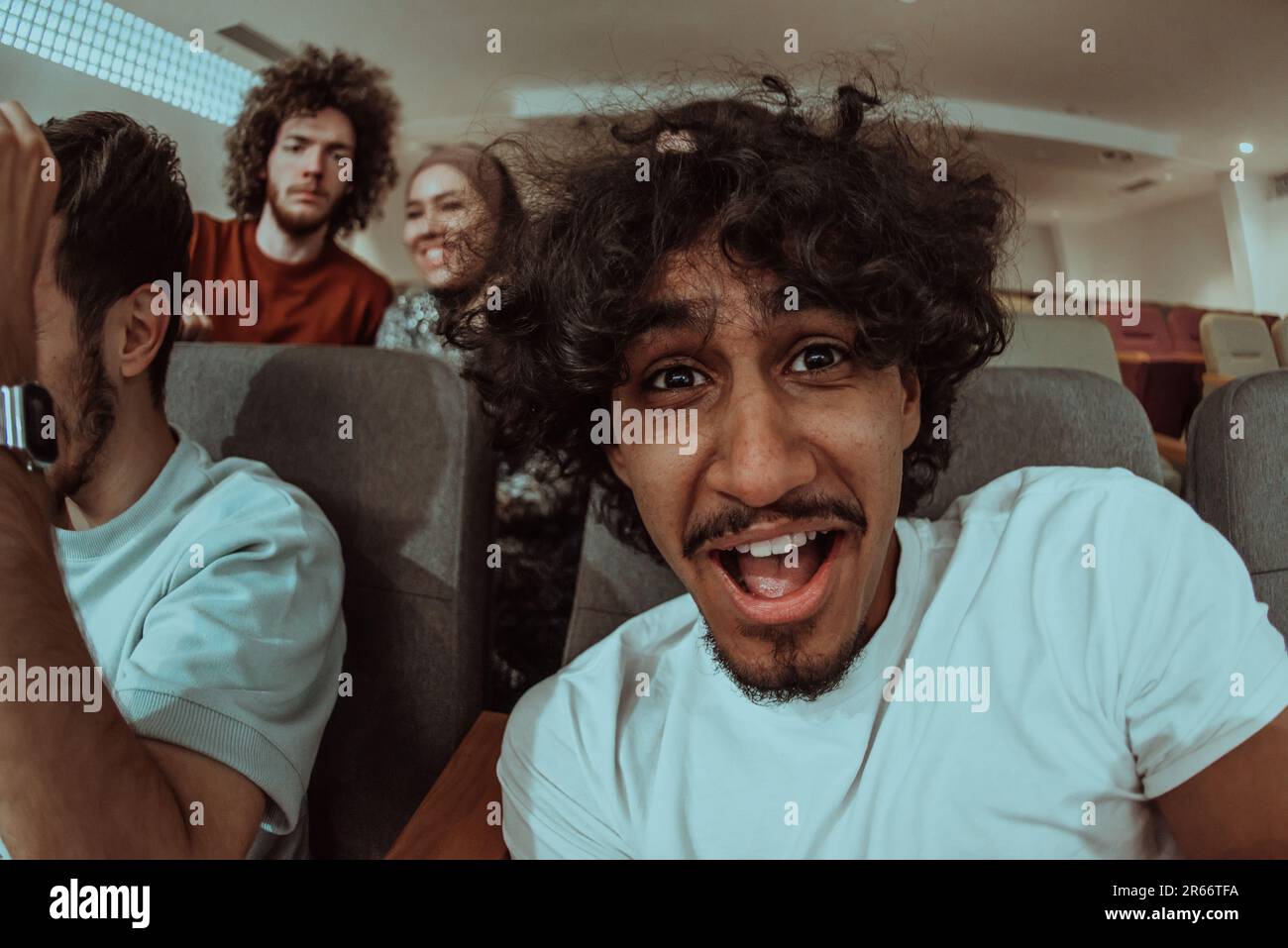 A diverse group of friends with terrified expressions together in a ...