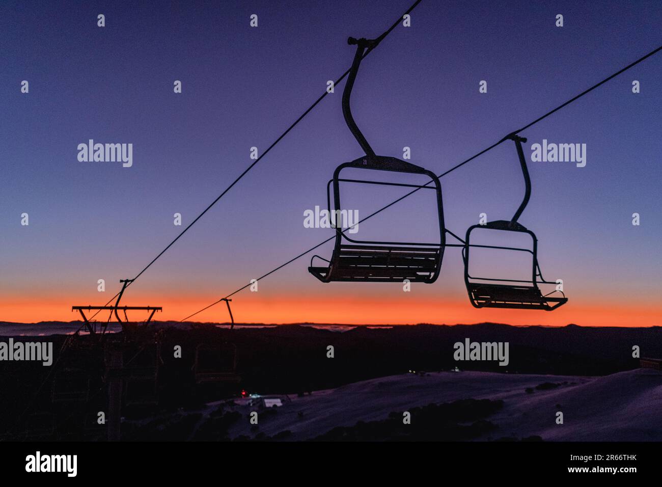 A breathtaking sunset sky is illuminated above a mountain landscape ...