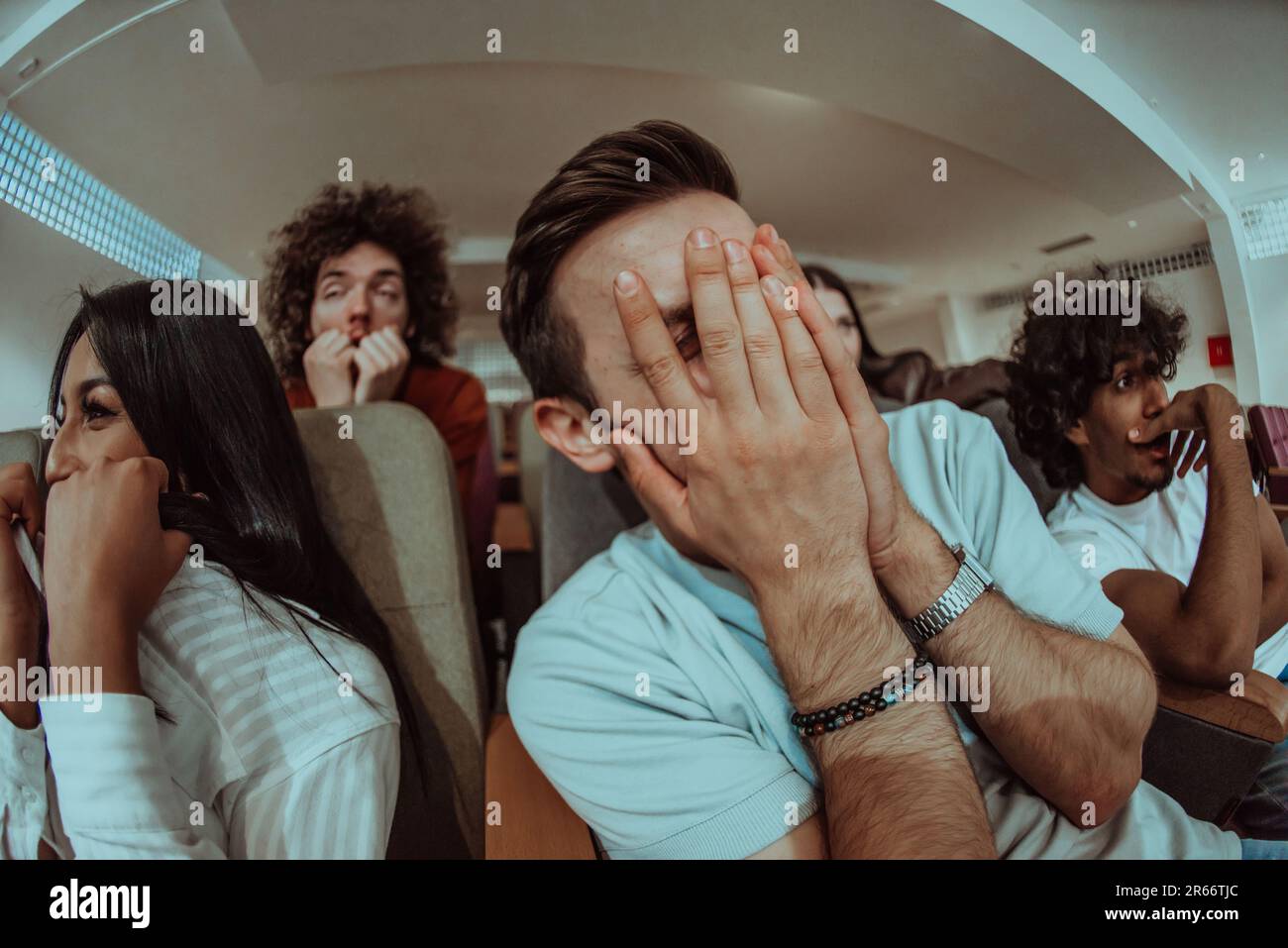 A diverse group of friends with terrified expressions together in a ...