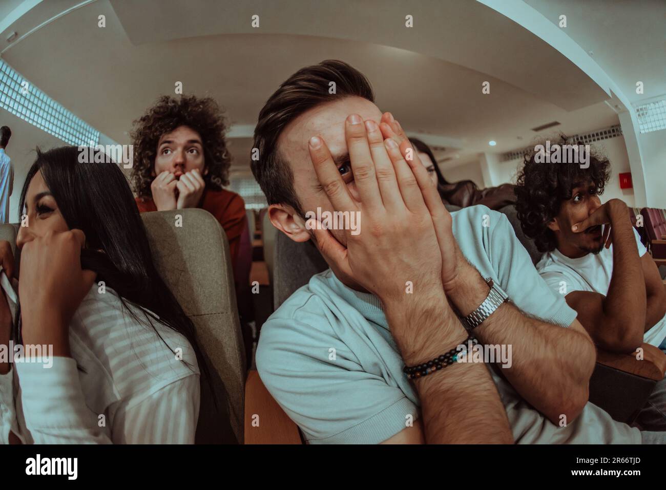 A diverse group of friends with terrified expressions together in a ...