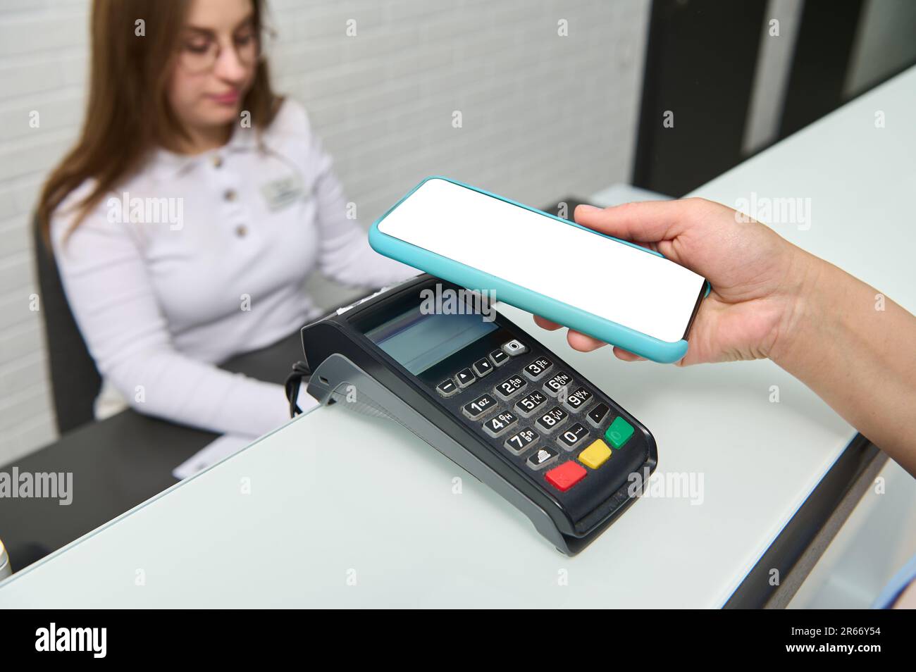 Close-up customer hand holds smartphone with white blank digital scree ...