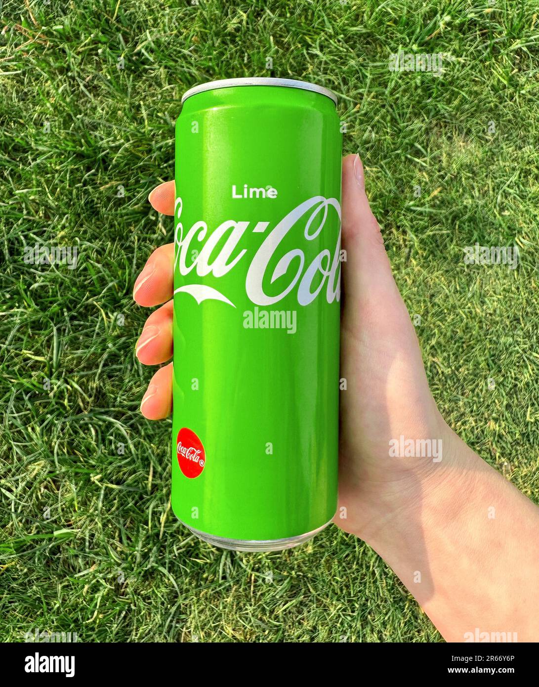 Lodz, Poland May 26 2023 Hand holding Cola drink in red can tin ...