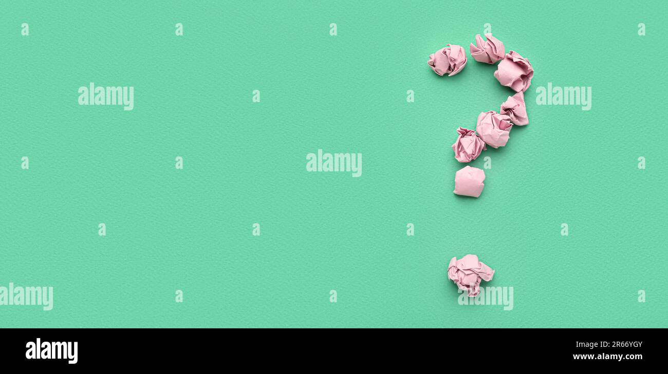 Question mark made of crumpled paper on green background with space for ...