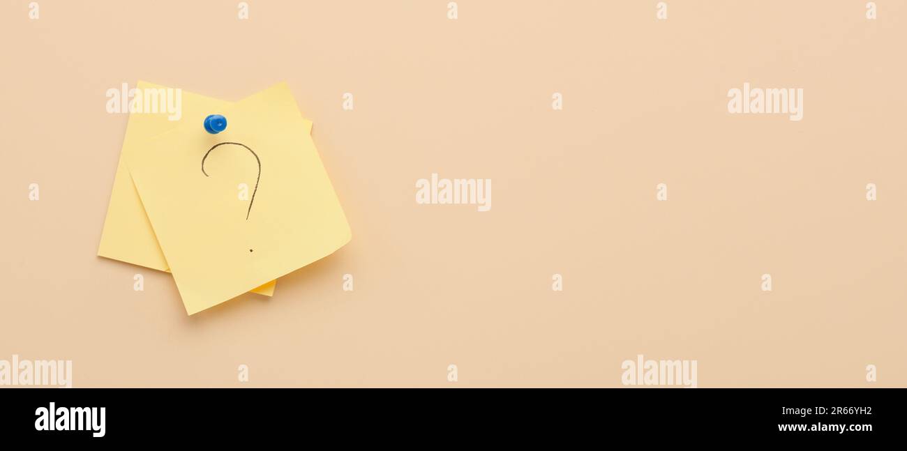 Sticky papers with question mark on beige background with space for ...