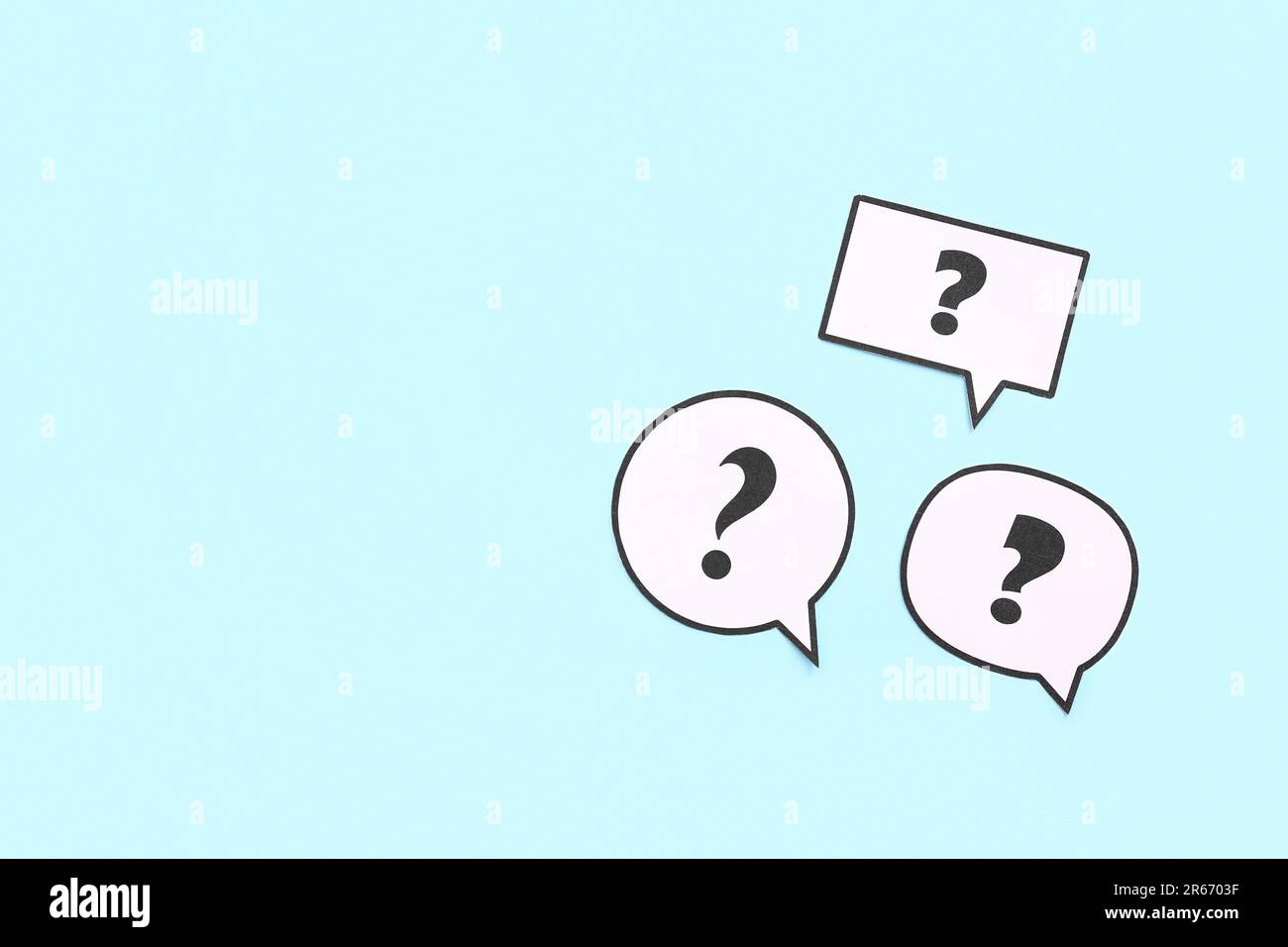 Speech bubbles with question marks on blue background Stock Photo - Alamy