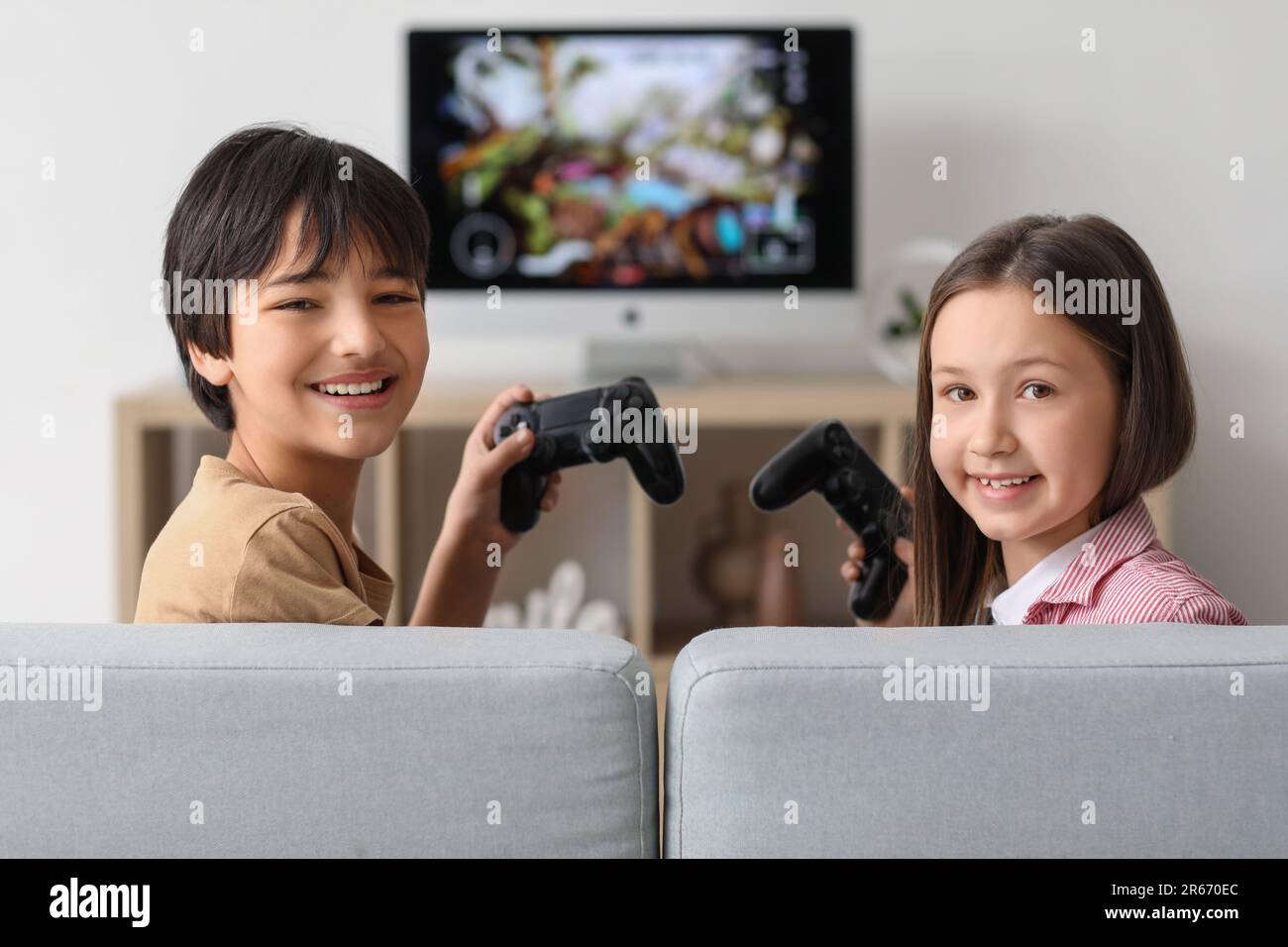 Little children playing video game at home Stock Photo - Alamy