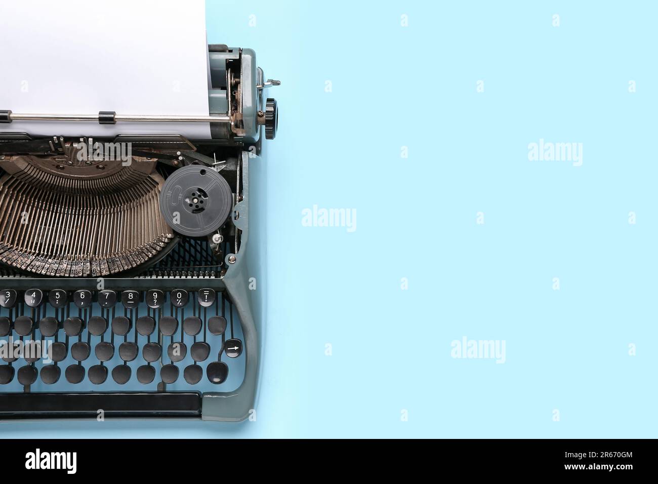 Vintage typewriter with blank paper sheet on blue background Stock ...