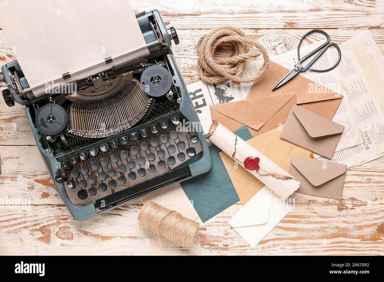 Composition with vintage typewriter, scroll and envelopes on white ...