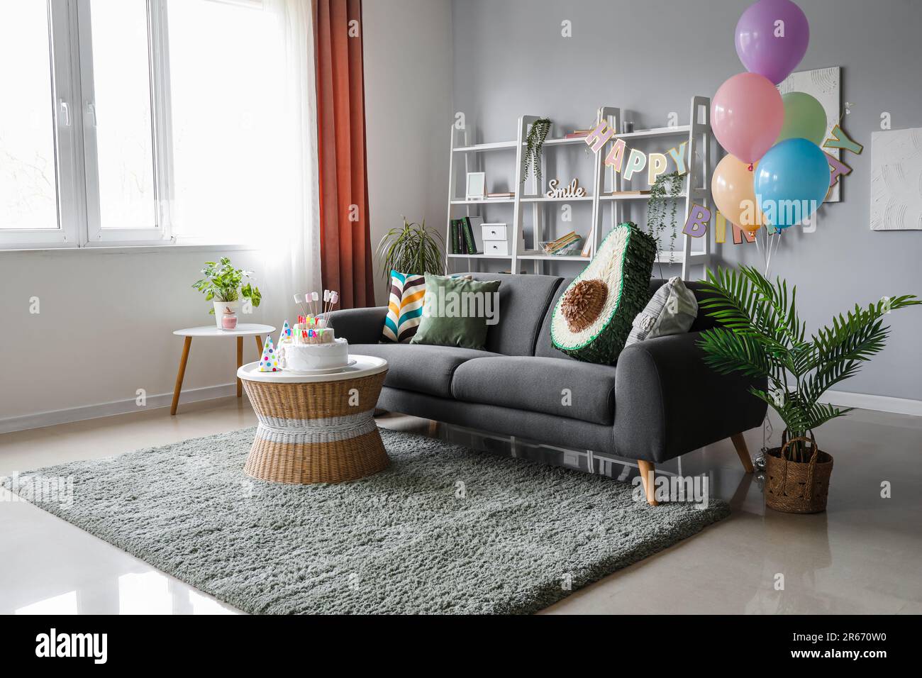 Interior of living room with birthday cake, balloons and pinata on grey ...