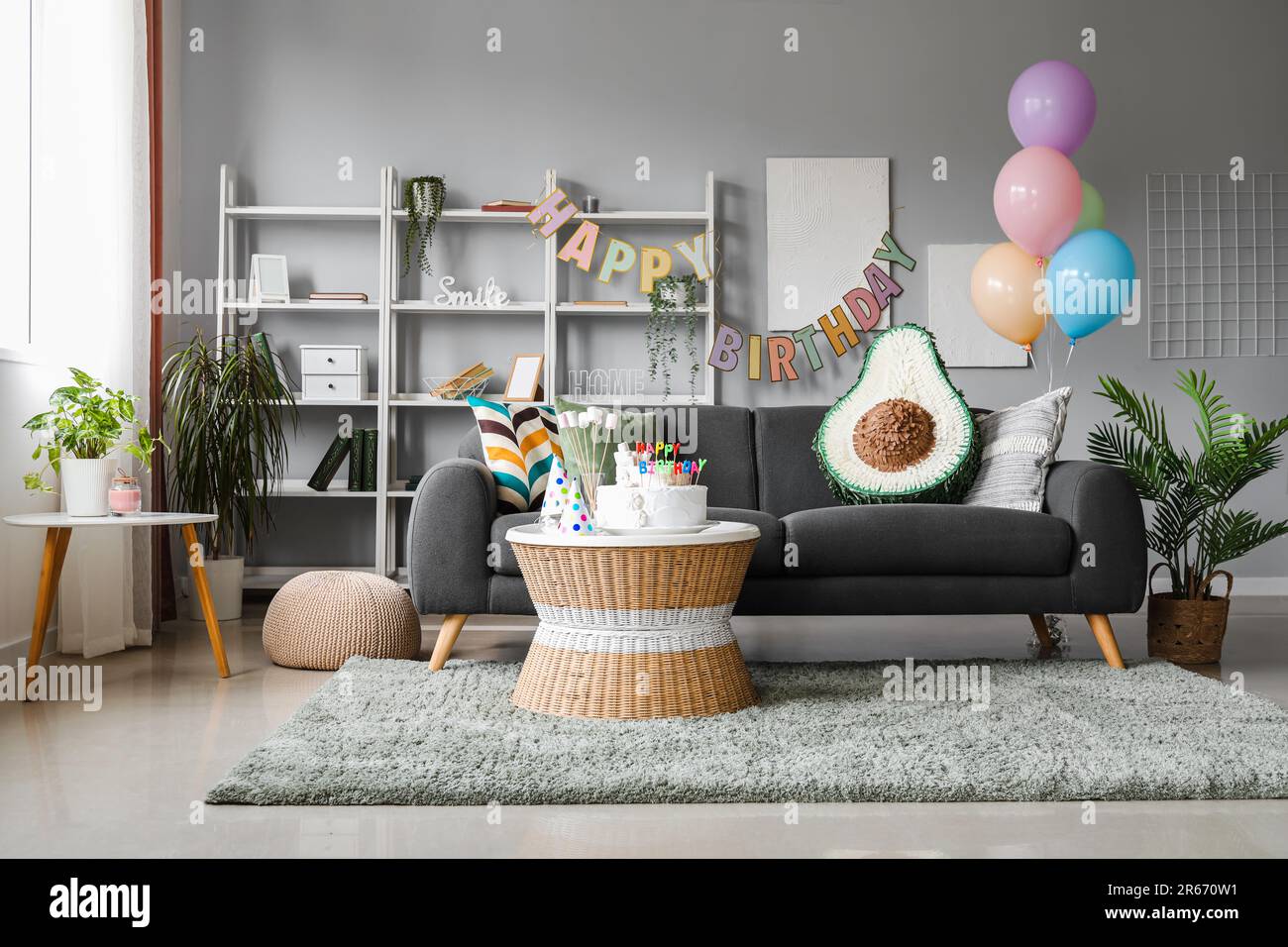 Interior of living room with birthday cake, balloons and pinata on grey ...