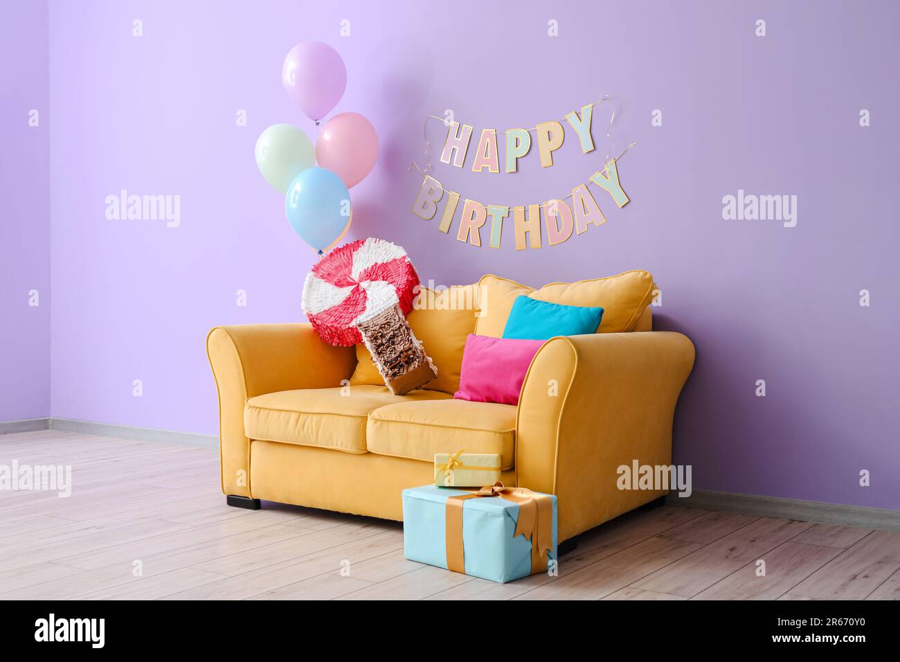 Interior of living room decorated for birthday with balloons, pinata ...