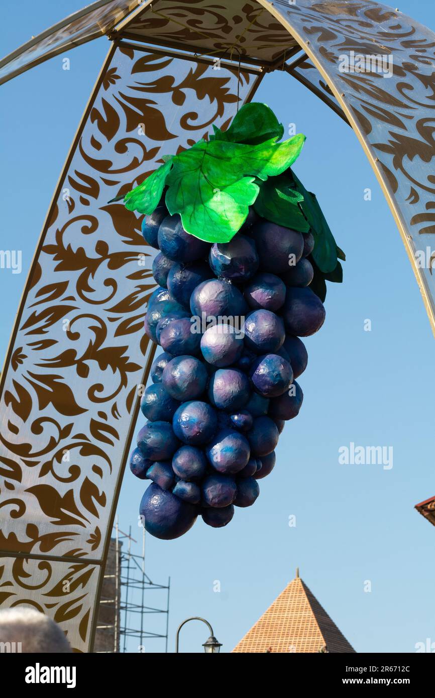 Artificial grapes. A giant artificial grape attached to a metal arch ...