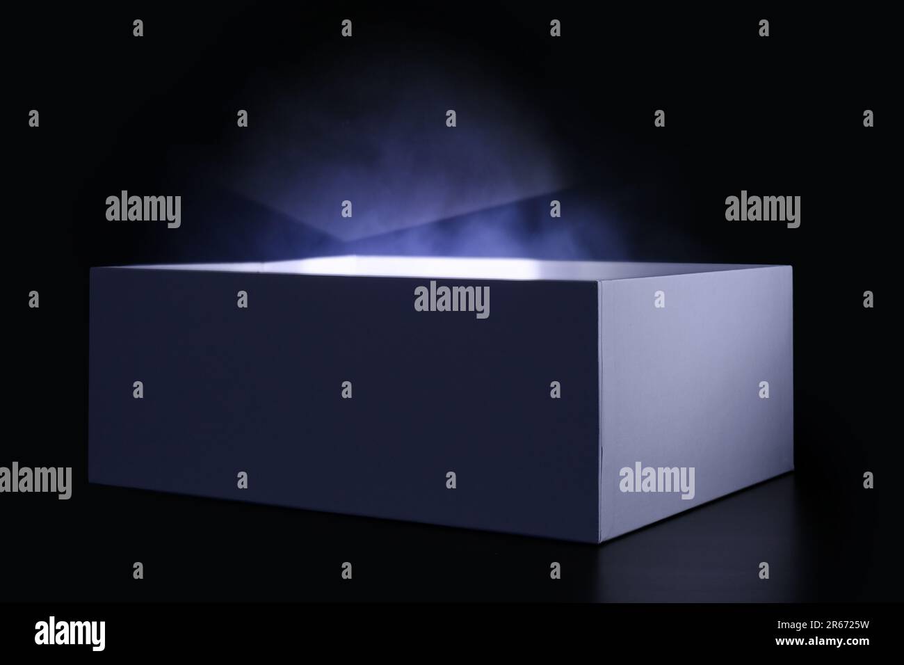 Camera flash in box on black background Stock Photo - Alamy