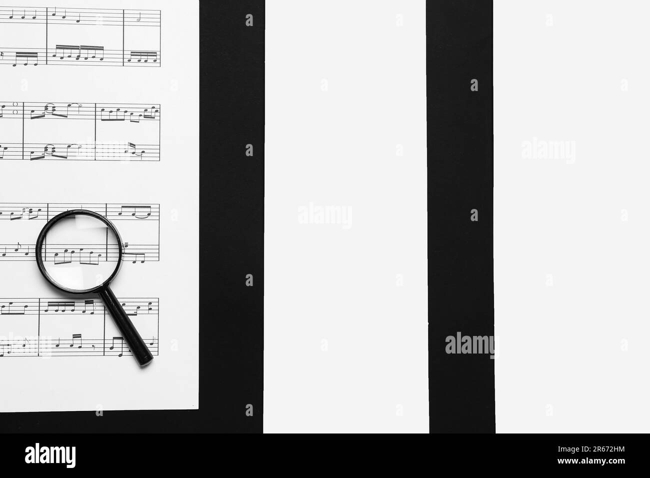 Magnifier with music sheet on black and white background Stock Photo ...