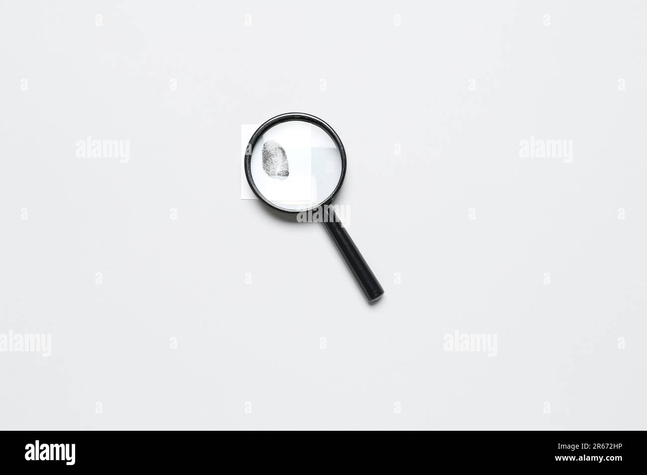 Magnifier and paper with fingerprint on grey background. Detective ...