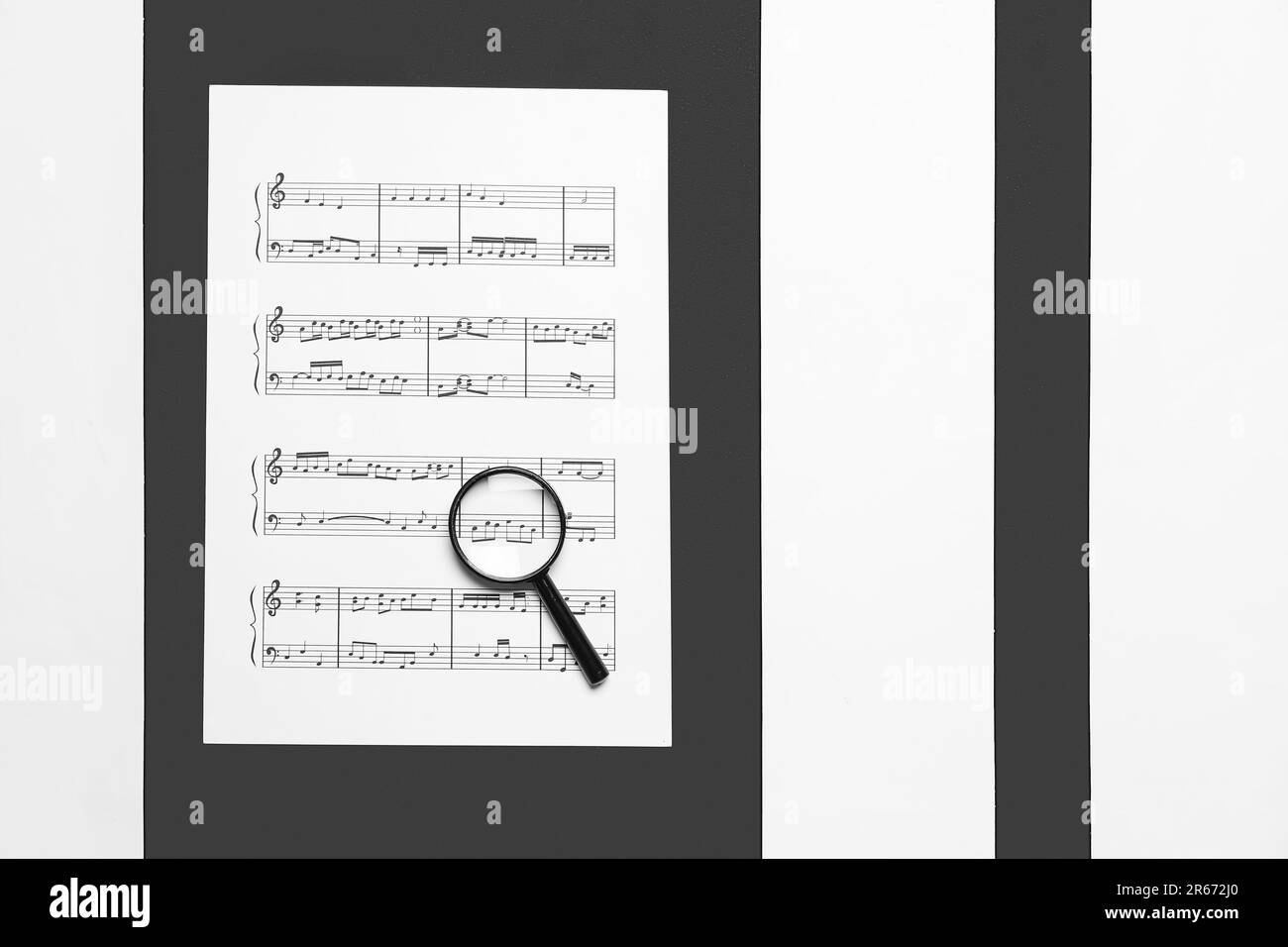 Magnifier with music sheet on black and white background Stock Photo ...
