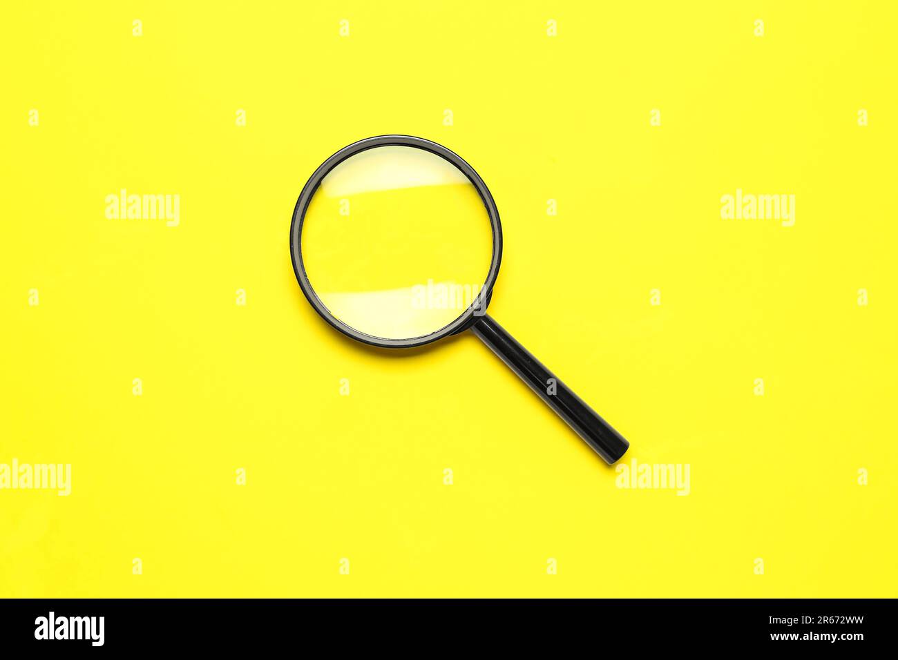 Black magnifiers on yellow background Stock Photo - Alamy