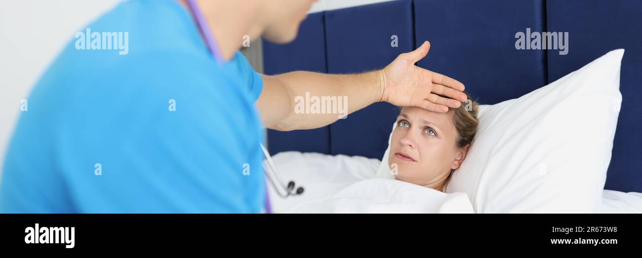 Doctor touching forehead of ill woman, examining of patient Stock Photo ...