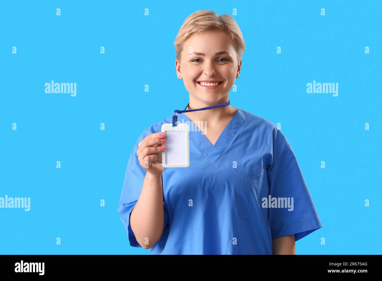 Female medical intern with badge on blue background Stock Photo - Alamy