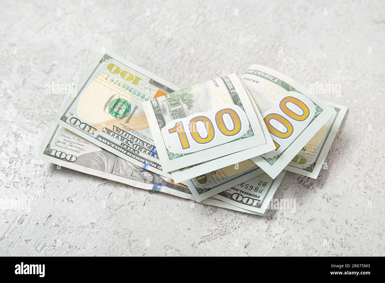 One hundred dollar banknotes on grey grunge background Stock Photo - Alamy