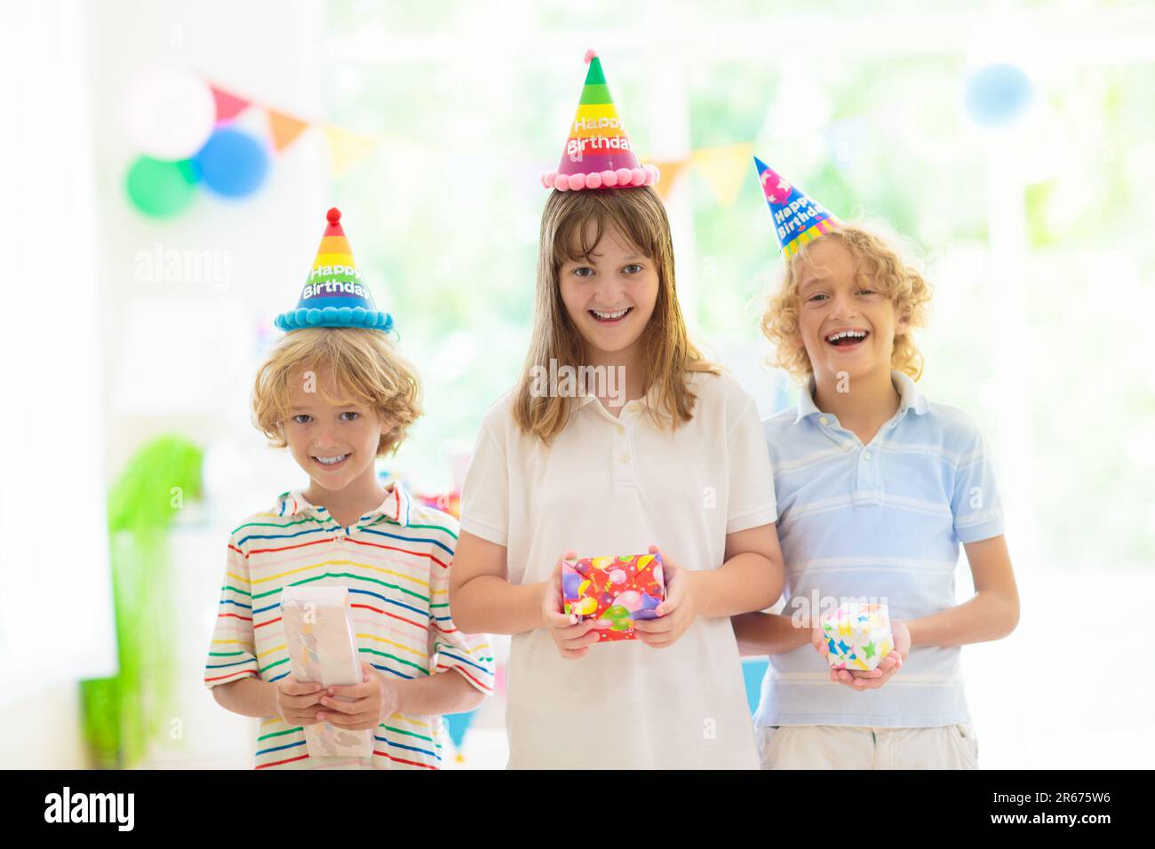 Kids birthday party. Children play with balloons and open presents ...