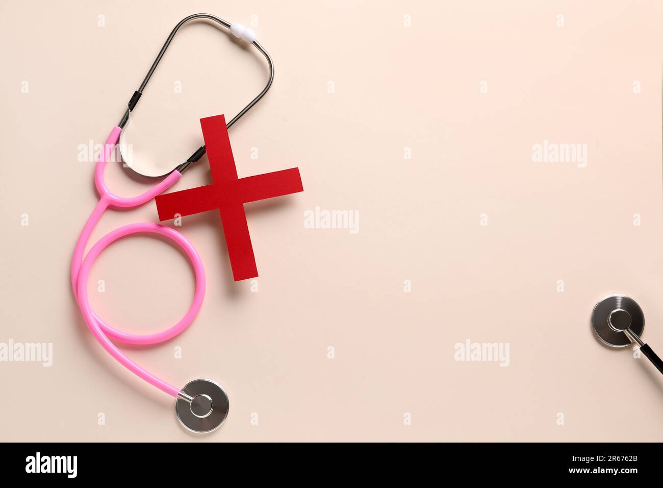 Stethoscope and red cross on light background Stock Photo - Alamy