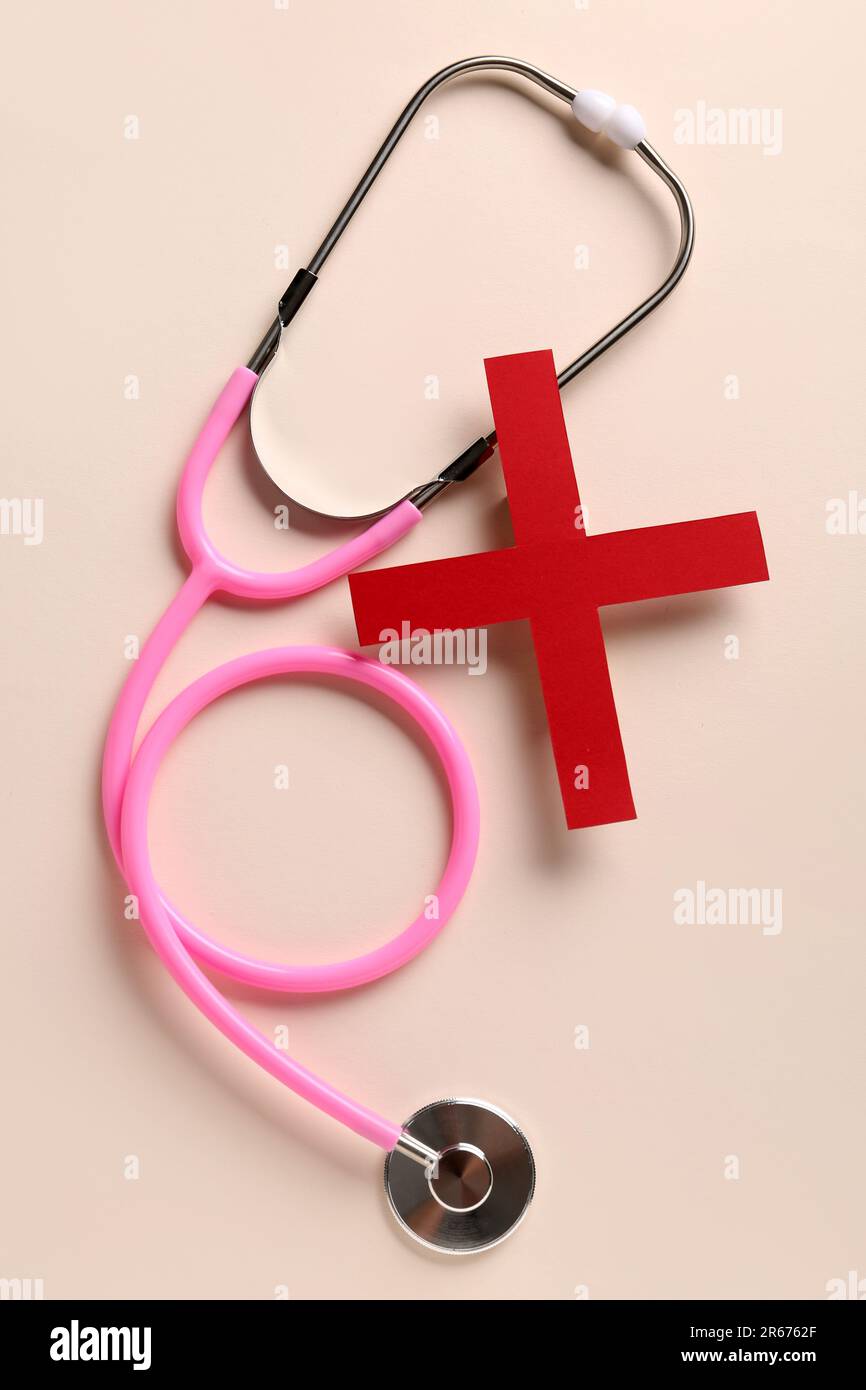 Stethoscope and red cross on light background Stock Photo - Alamy