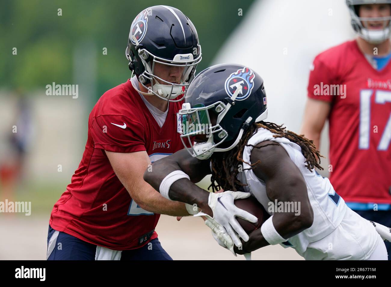 Tennessee Titans quarterback Will Levis, left, hands off to running ...