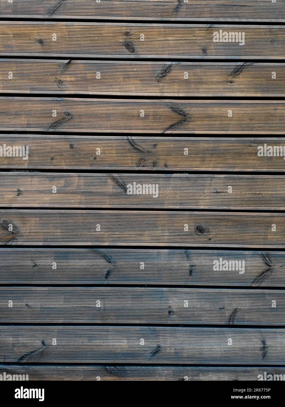 Fluted pine wood terrace freshly impregnated with dark brown oil ...