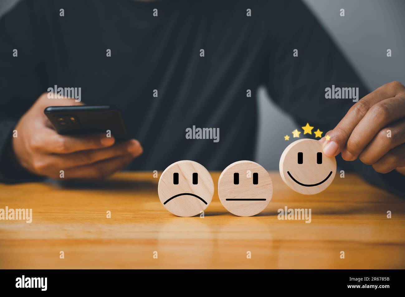 Selecting a smiley face on a wooden block circle Stock Photo - Alamy