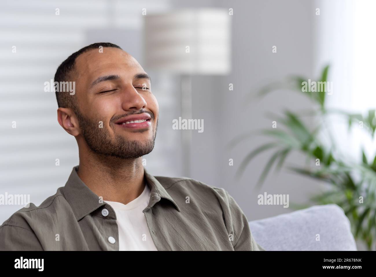 Portrait of the face of a smiling young Latin American man thoughtfully ...