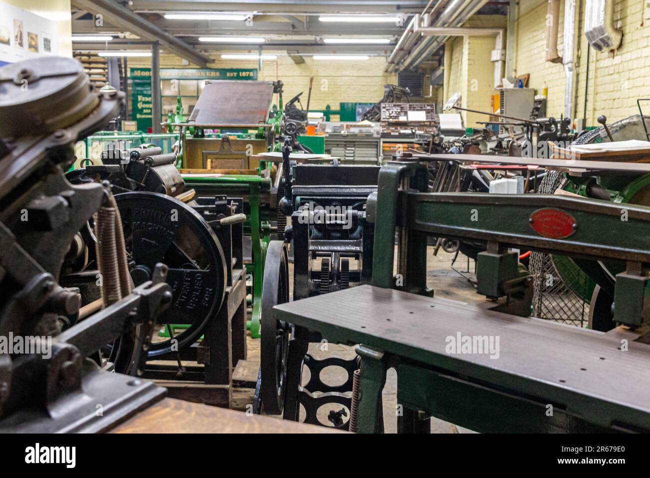 An industrial warehouse with a multitude of machines and wooden work ...