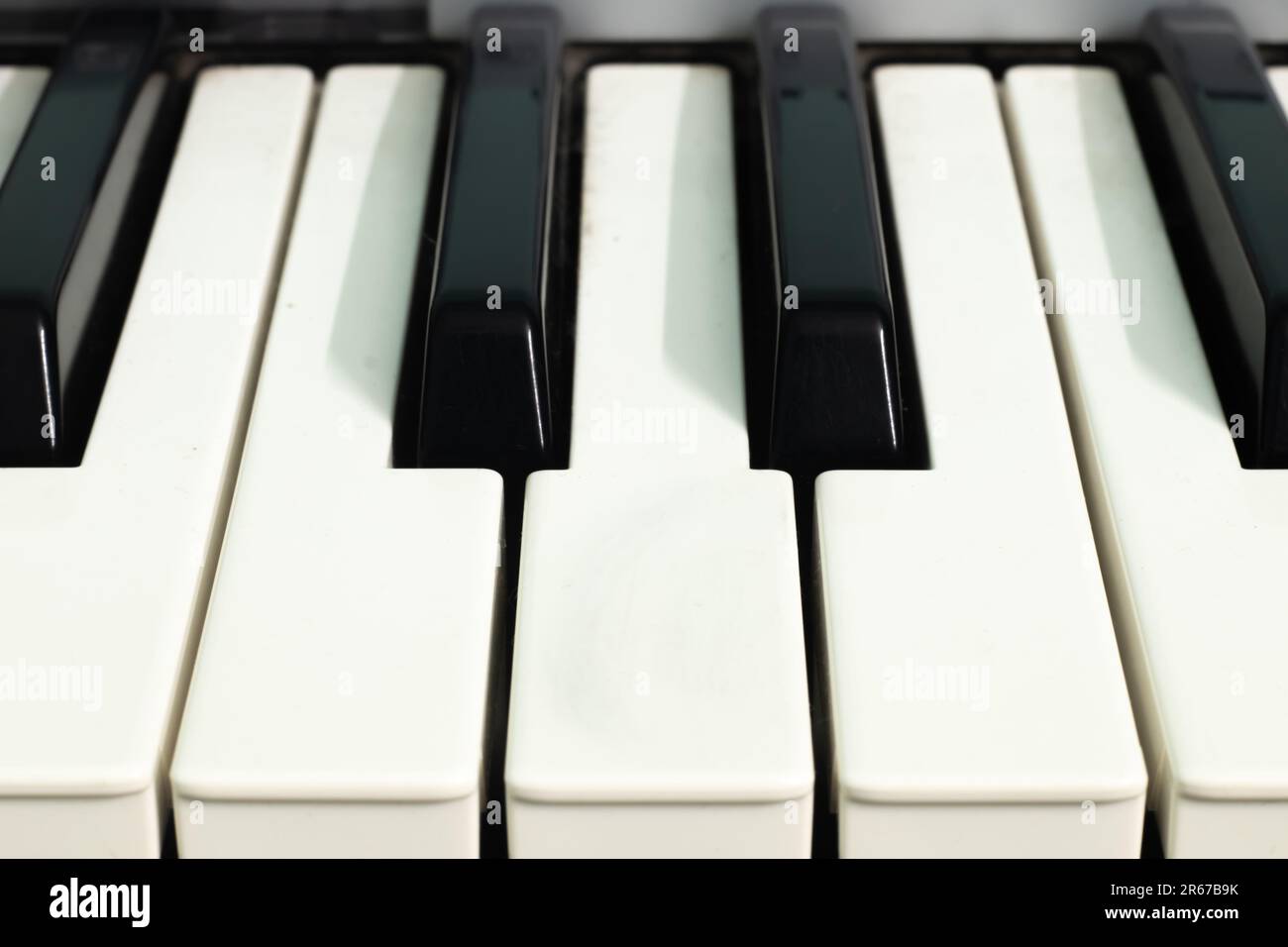 A top-down view of black and white keys of a grand piano, showing the ...