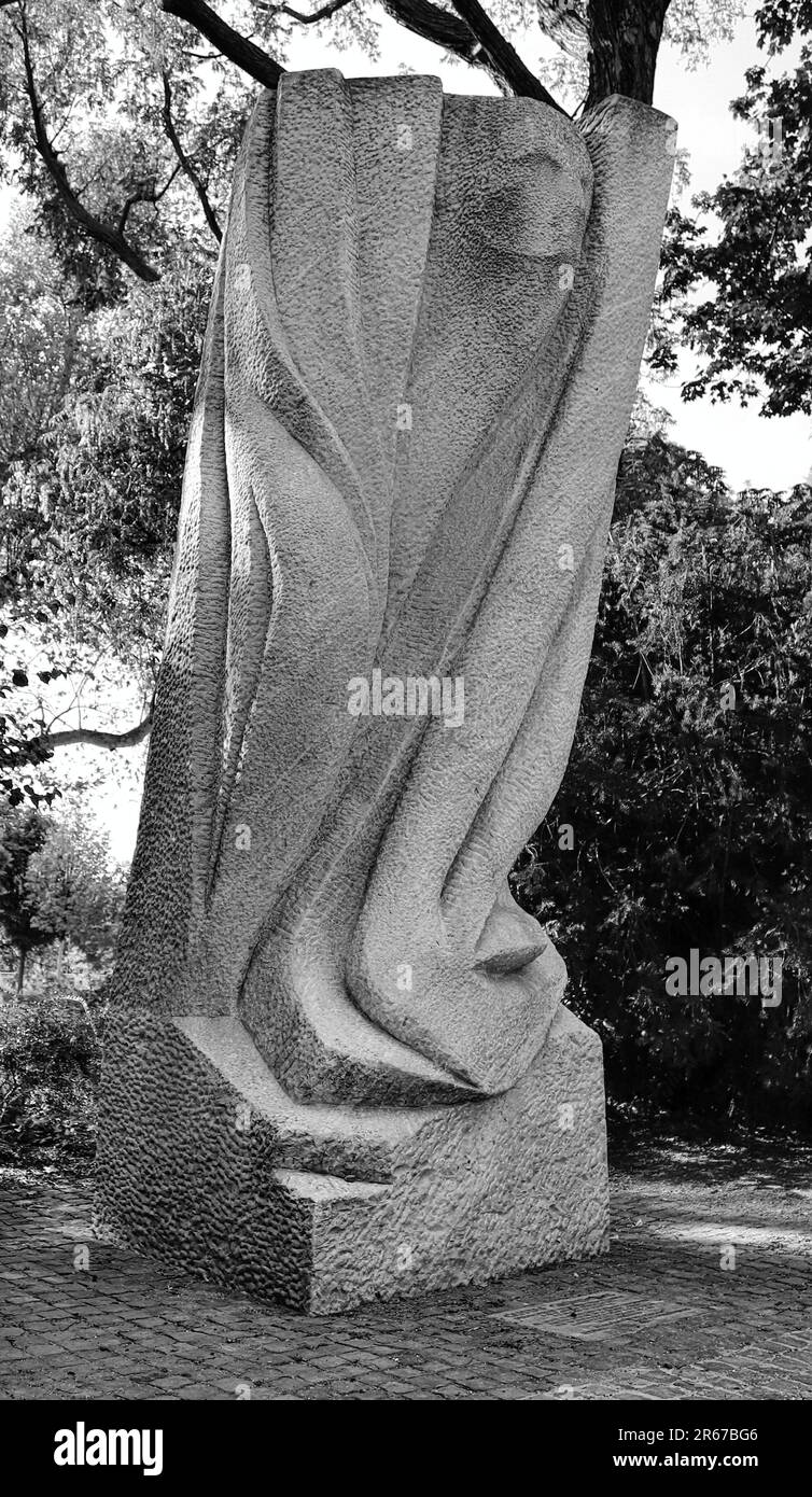 This striking statue is made to look like it is wrapped up in a cloak ...