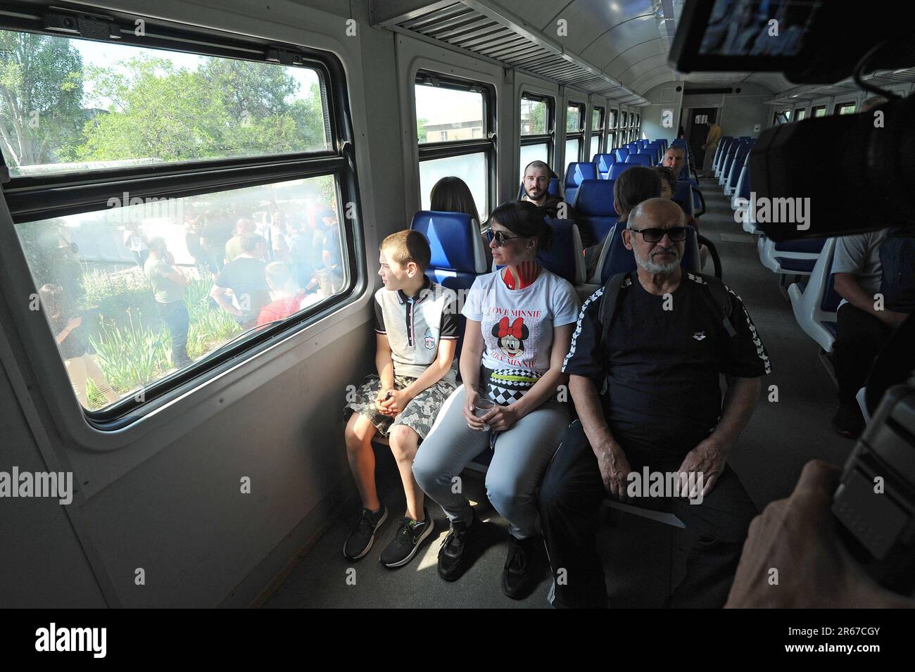 ZAPORIZHZHIA, UKRAINE - JUNE 7, 2023 - People sit on an evacuation ...