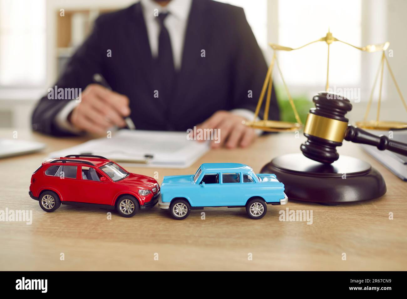 Close up of two toy model cars on background of judge who is conducting ...