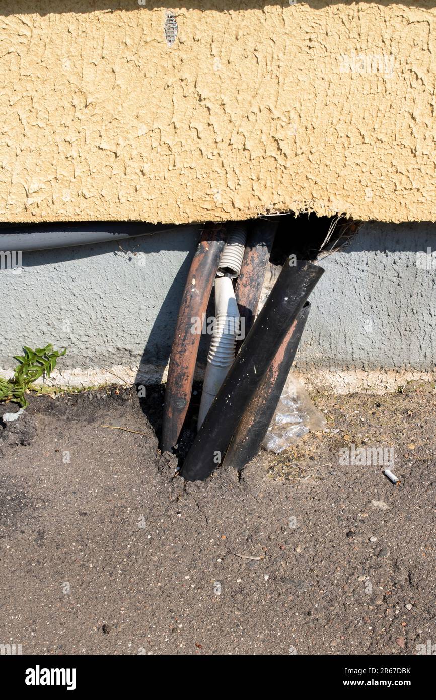 Electrical wires stick out of the ground near the house Stock Photo - Alamy