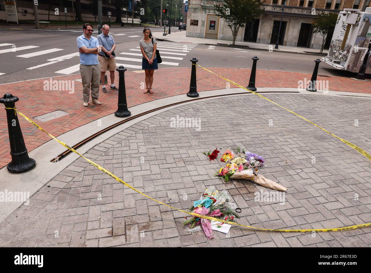 Community members pay their respects at an impromptu memorial at Monroe ...