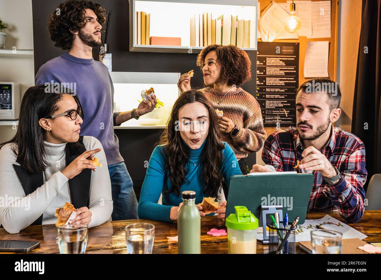 Group of young colleagues or university students using computer laptop ...