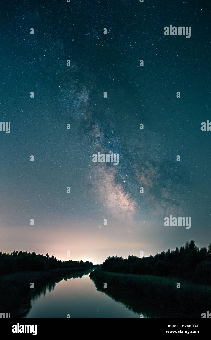 A stunning vertical shot of the night sky featuring a beautiful milky ...